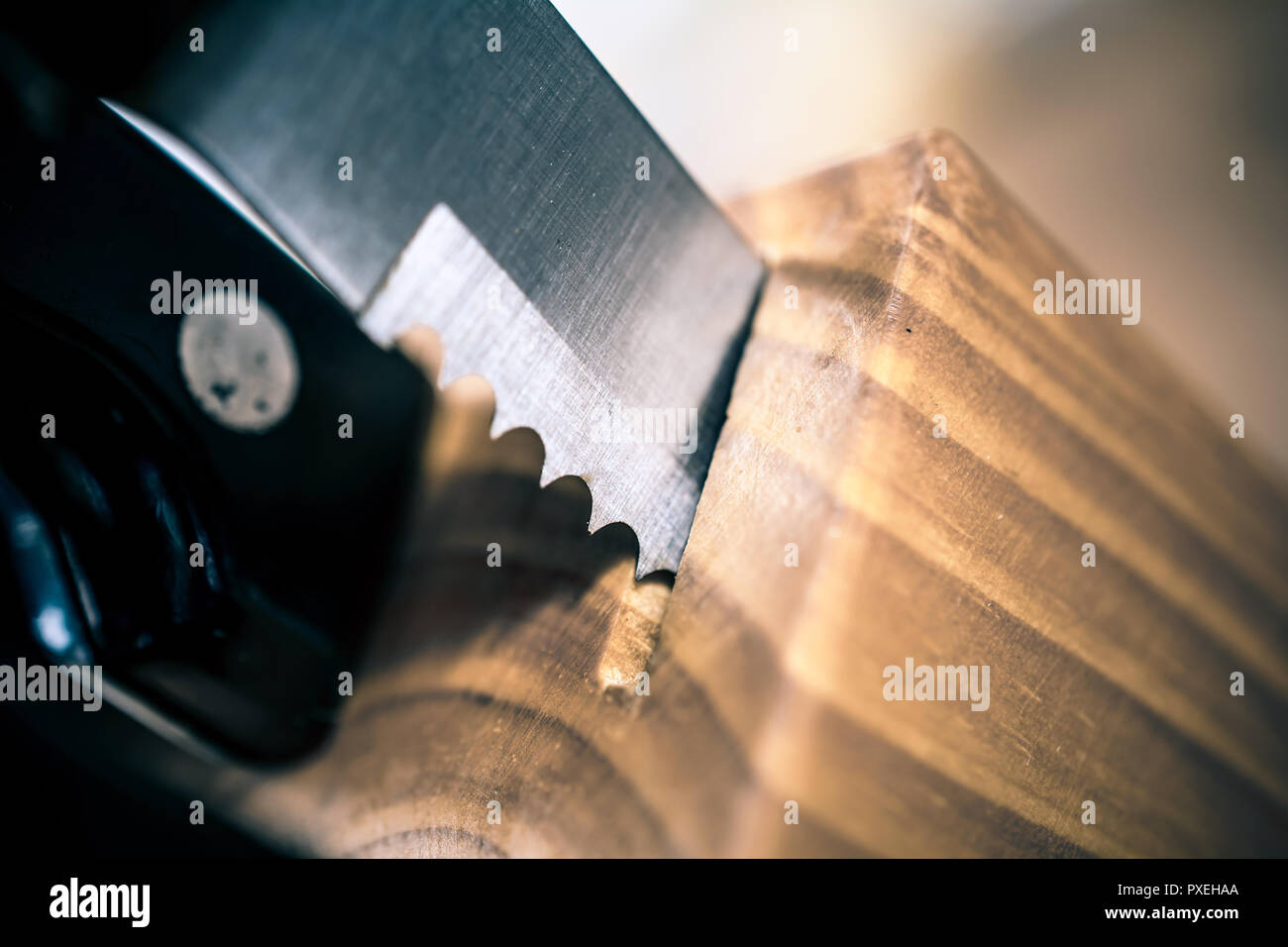 Macro Of A Jagged Steak Knife Partially Pulled Out Of A Kitchen Knive ...