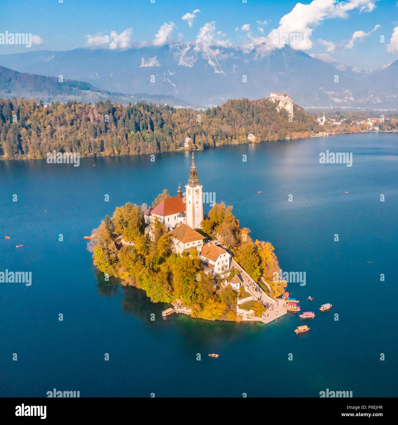 Aerial view of Bled island on lake Bled, and Bled castle and mountains ...