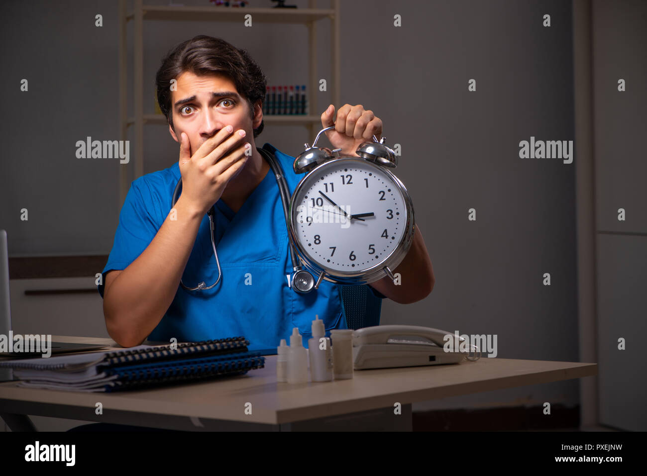 Young handsome doctor working night shift in hospital Stock Photo - Alamy