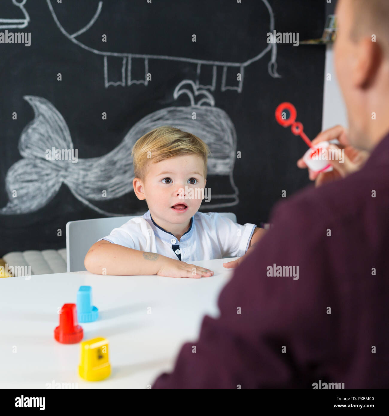 Cute little toddler boy at child therapy session Stock Photo - Alamy