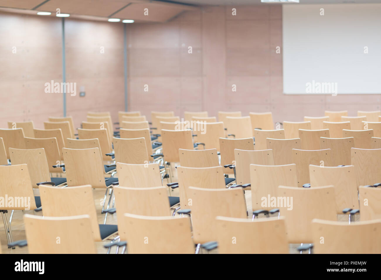 Empty wooden seats in a cotmporary lecture hall Stock Photo - Alamy