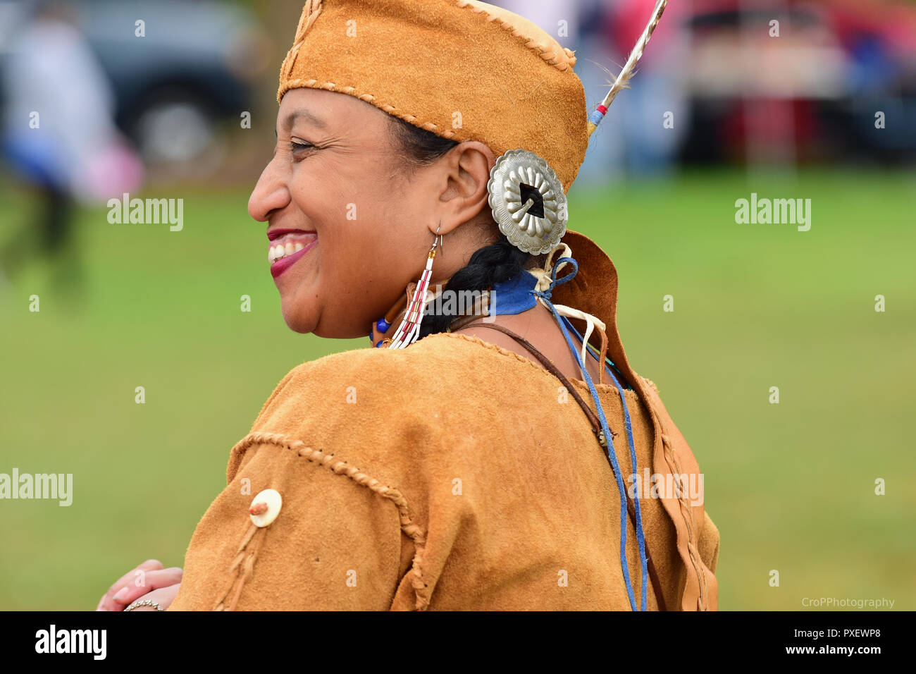 Female Native American dressed in traditional clothing and feathered ...
