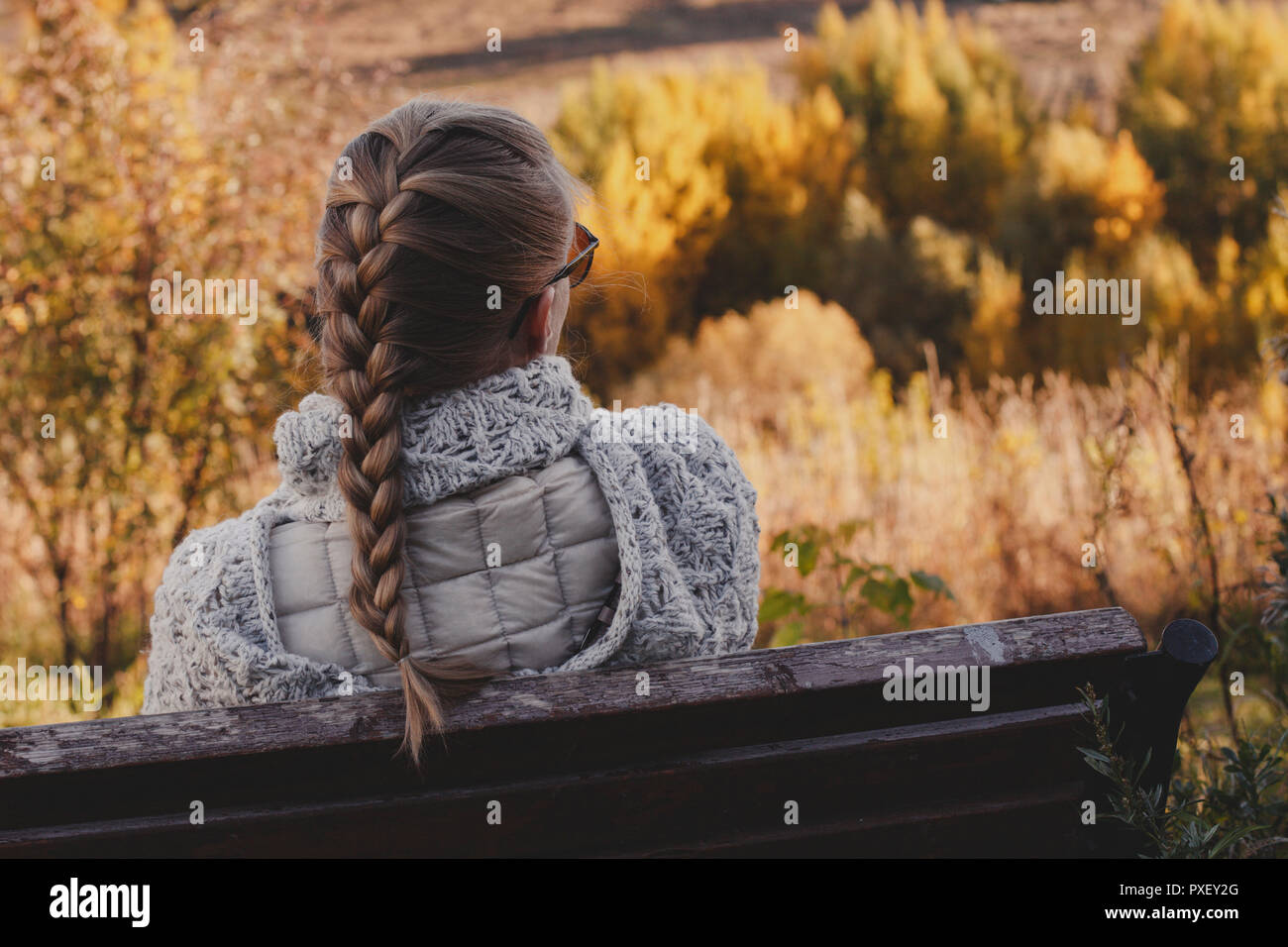Blonde girl on park bench hi-res stock photography and images - Alamy
