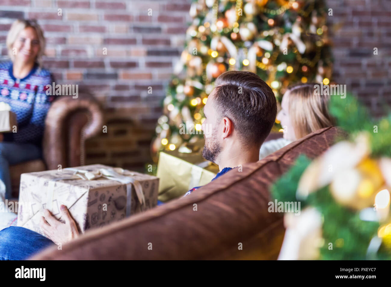 Friends celebrating christmas giving hi-res stock photography and ...