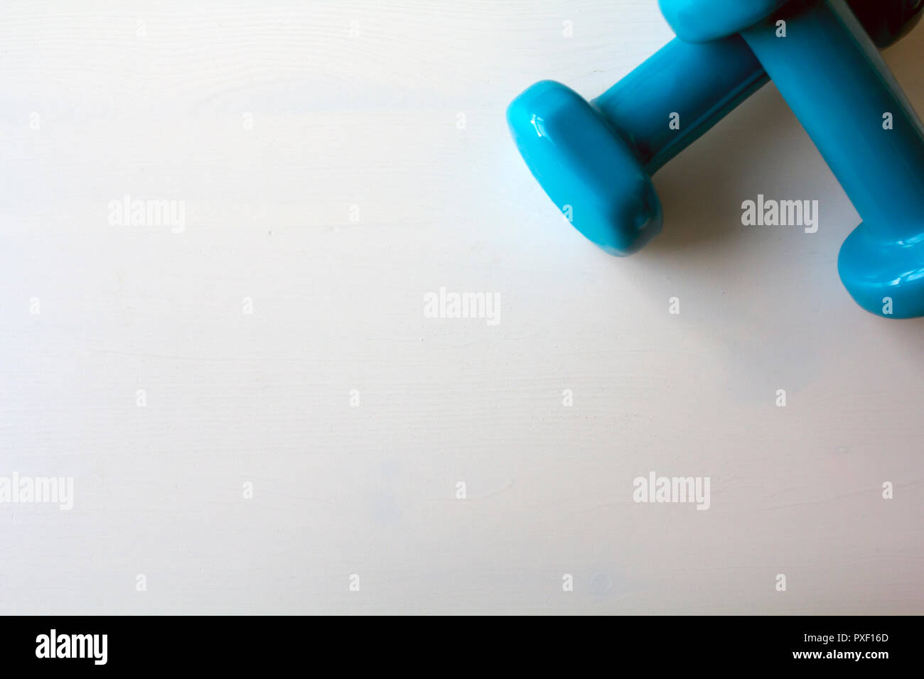 Two blue dumbbells on white background Stock Photo - Alamy