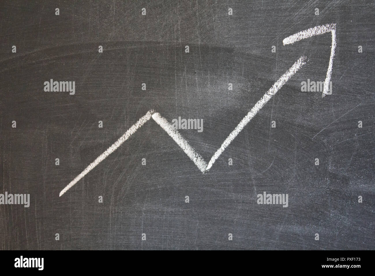 hand drawing chalk in arrow upward shape on black board background ...