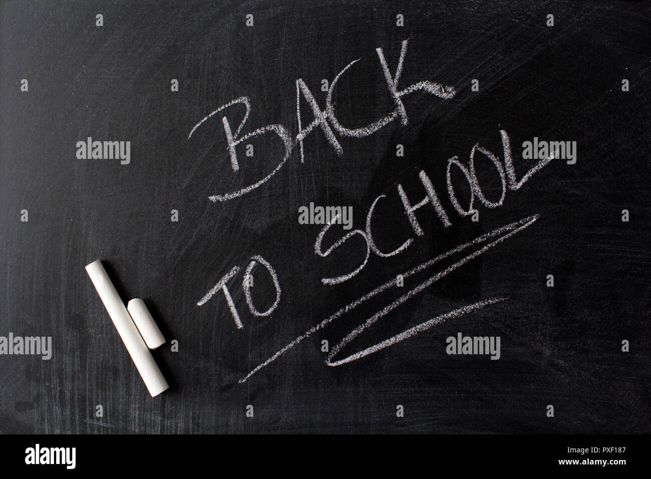 Back to school written in white chalk on a chalkboard Stock Photo - Alamy