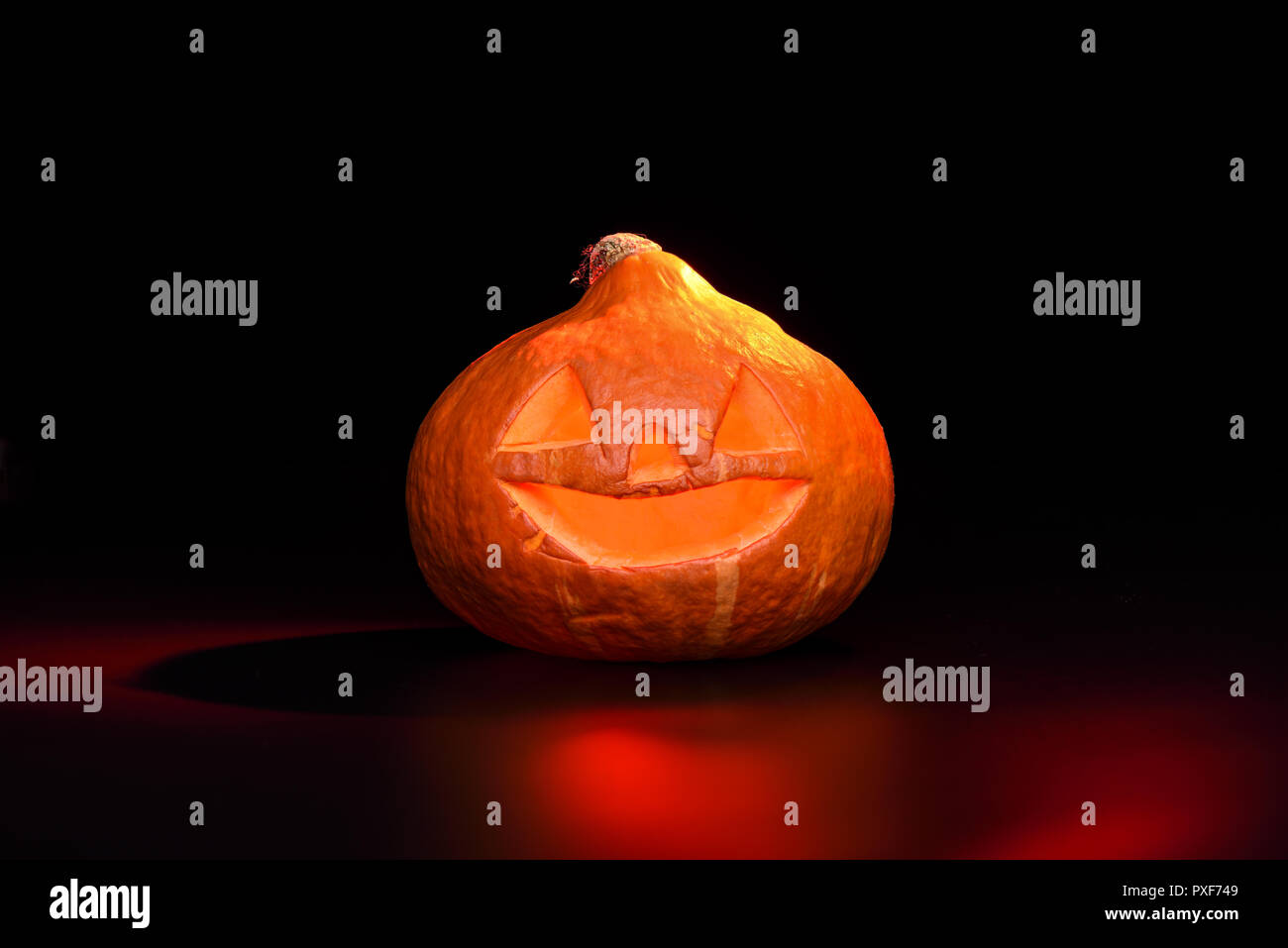 Halloween pumpkin on black background with red backlight. Border design ...