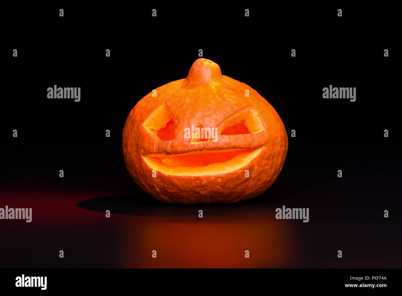 Halloween pumpkin lantern over black background with red backlight ...