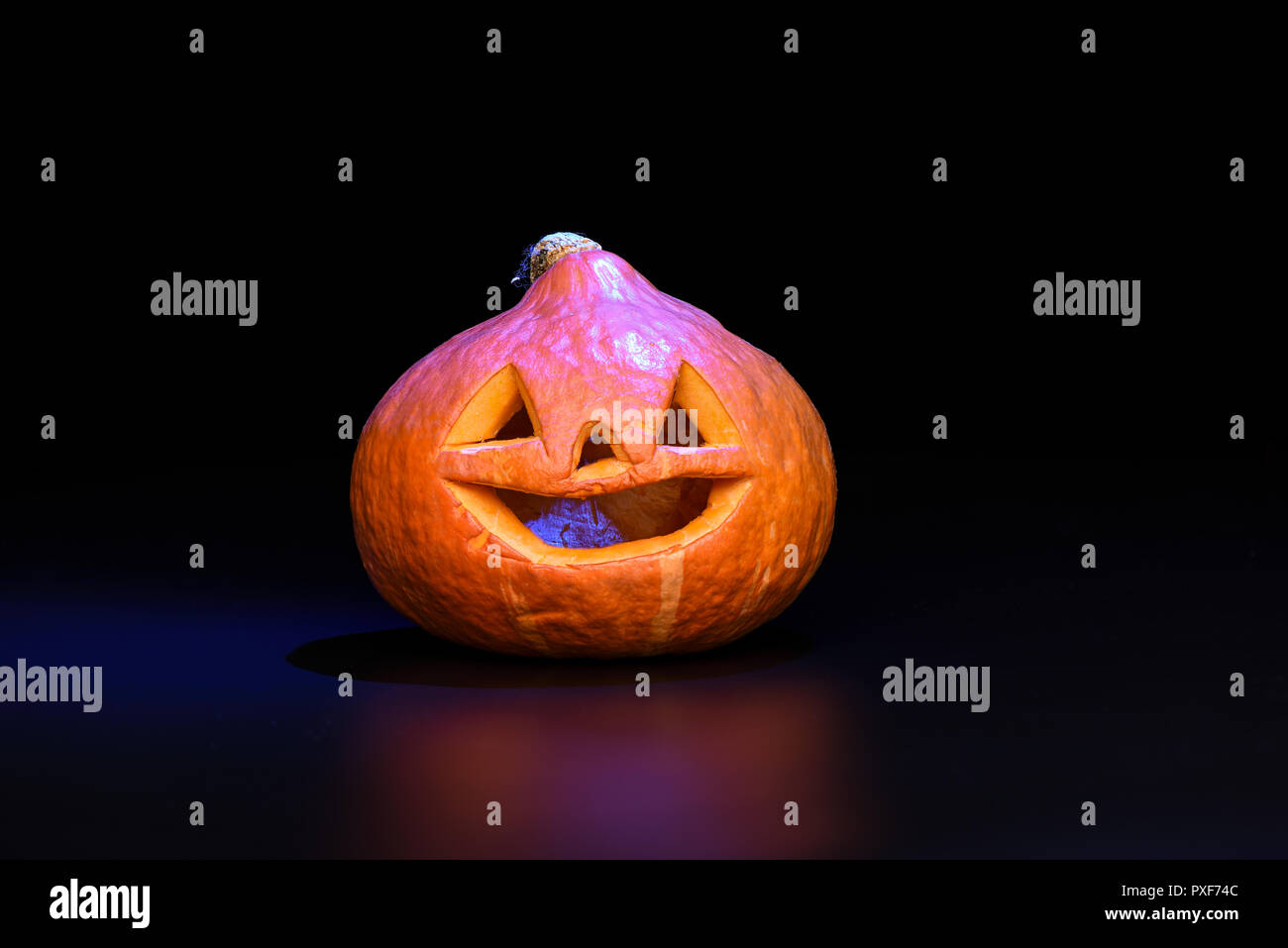 Halloween pumpkin isolated on black background with blue backlight ...
