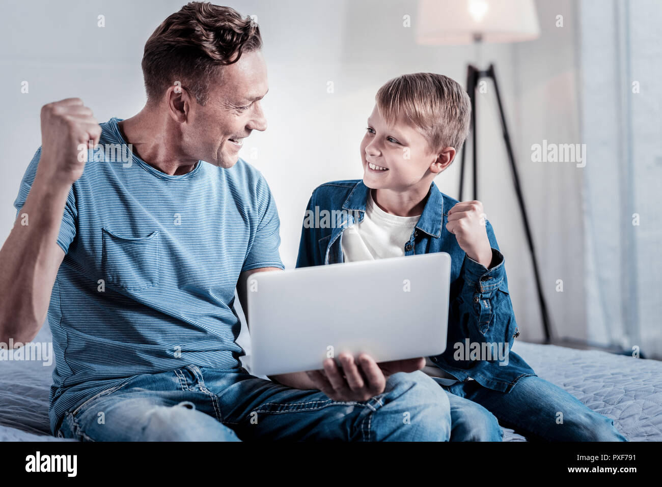 Joyful happy boy rejoicing and looking at his father Stock Photo - Alamy