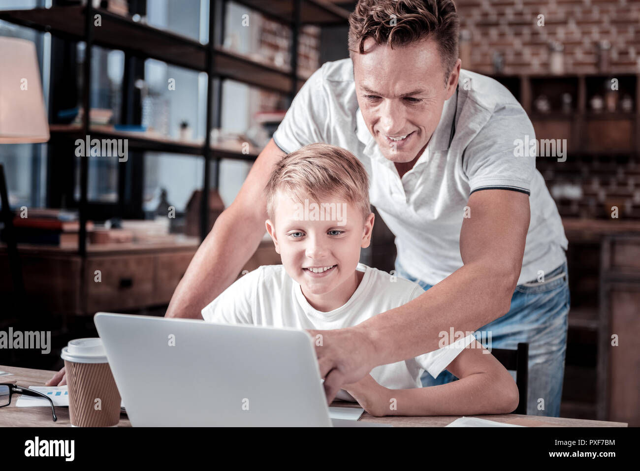 Caring attentive father standing and giving advices to his son Stock ...