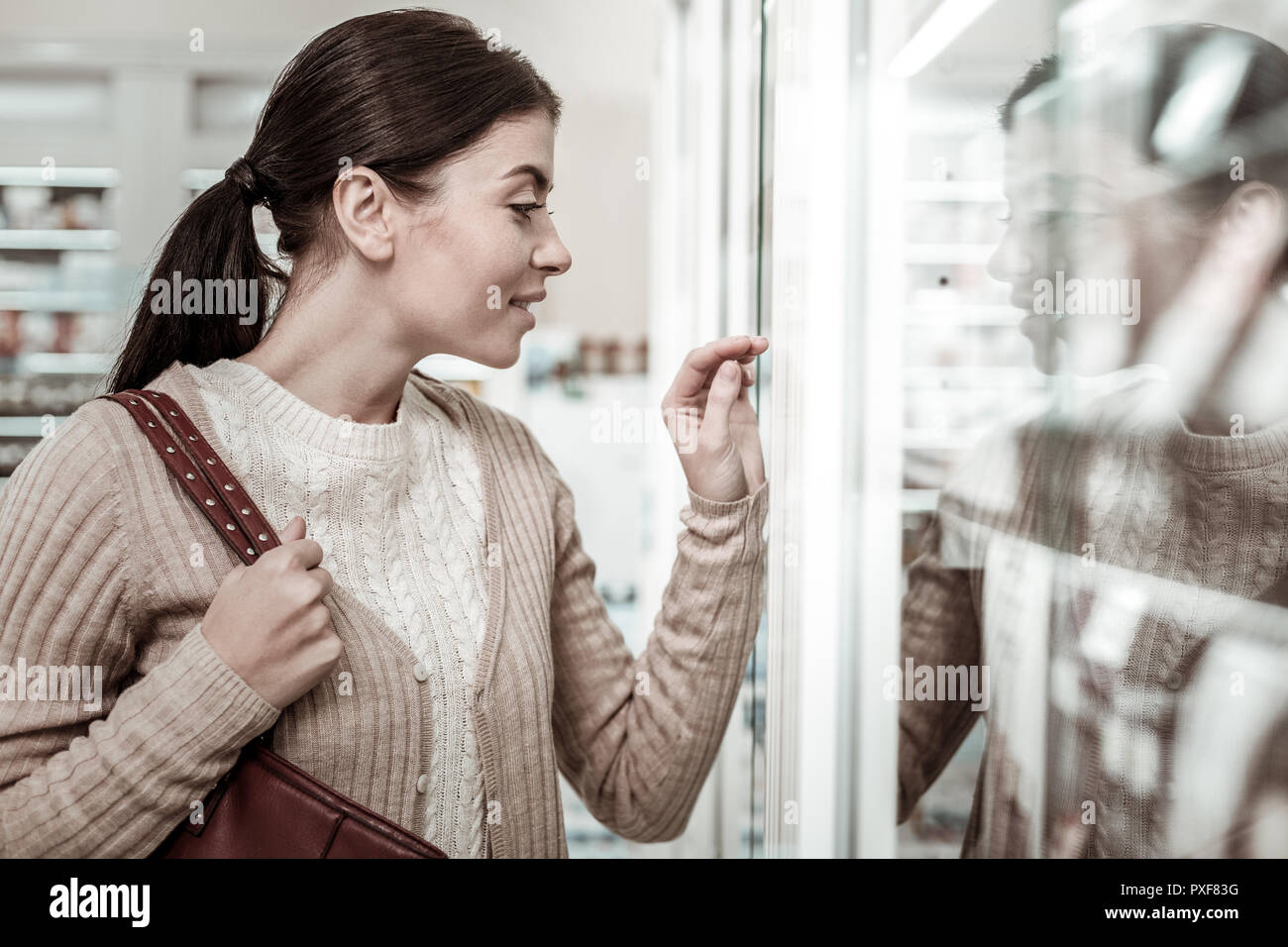 Mother looking at glass window in drugstore choosing medicine for ...