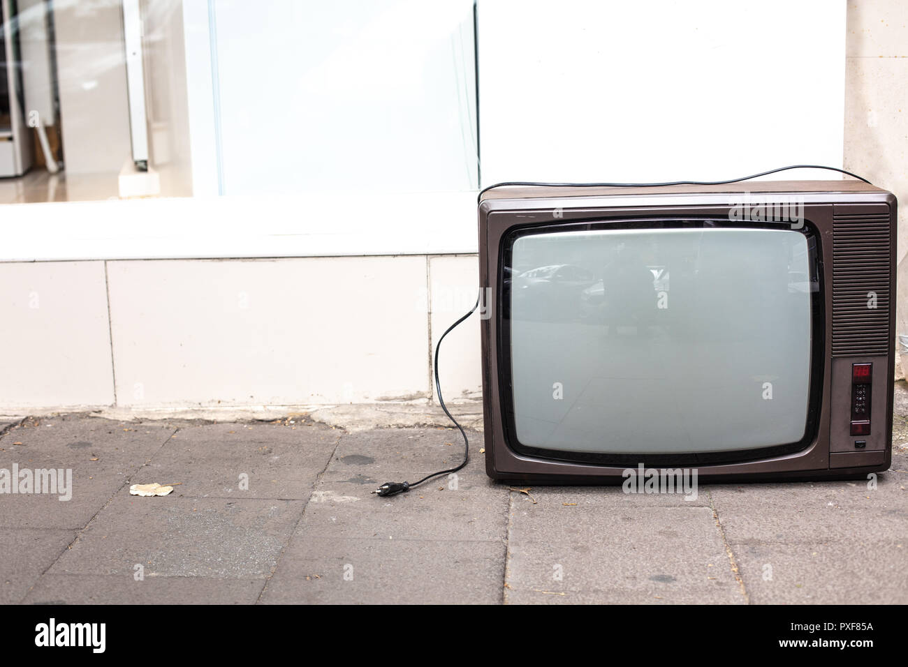 An old broken TV left on the street. High angle view Stock Photo - Alamy