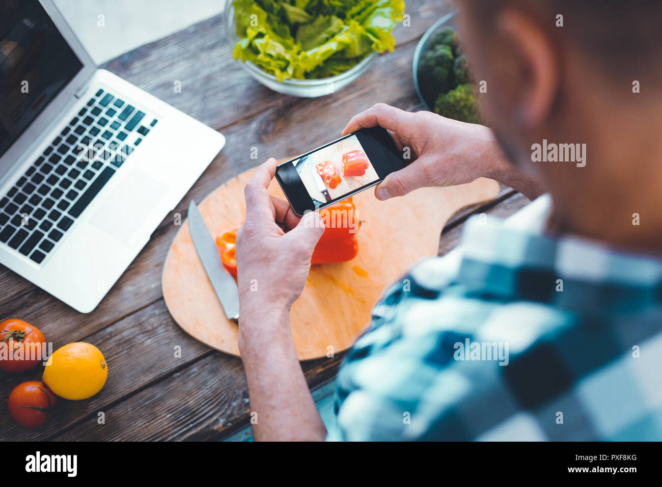 Top view of a nice adult man taking photos of food Stock Photo - Alamy