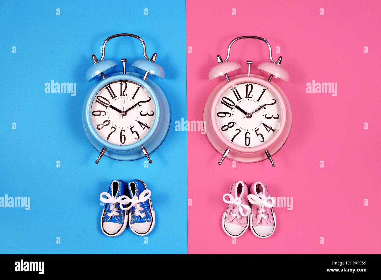 Two alarm clocks on blue pink background, twins concept Stock Photo - Alamy