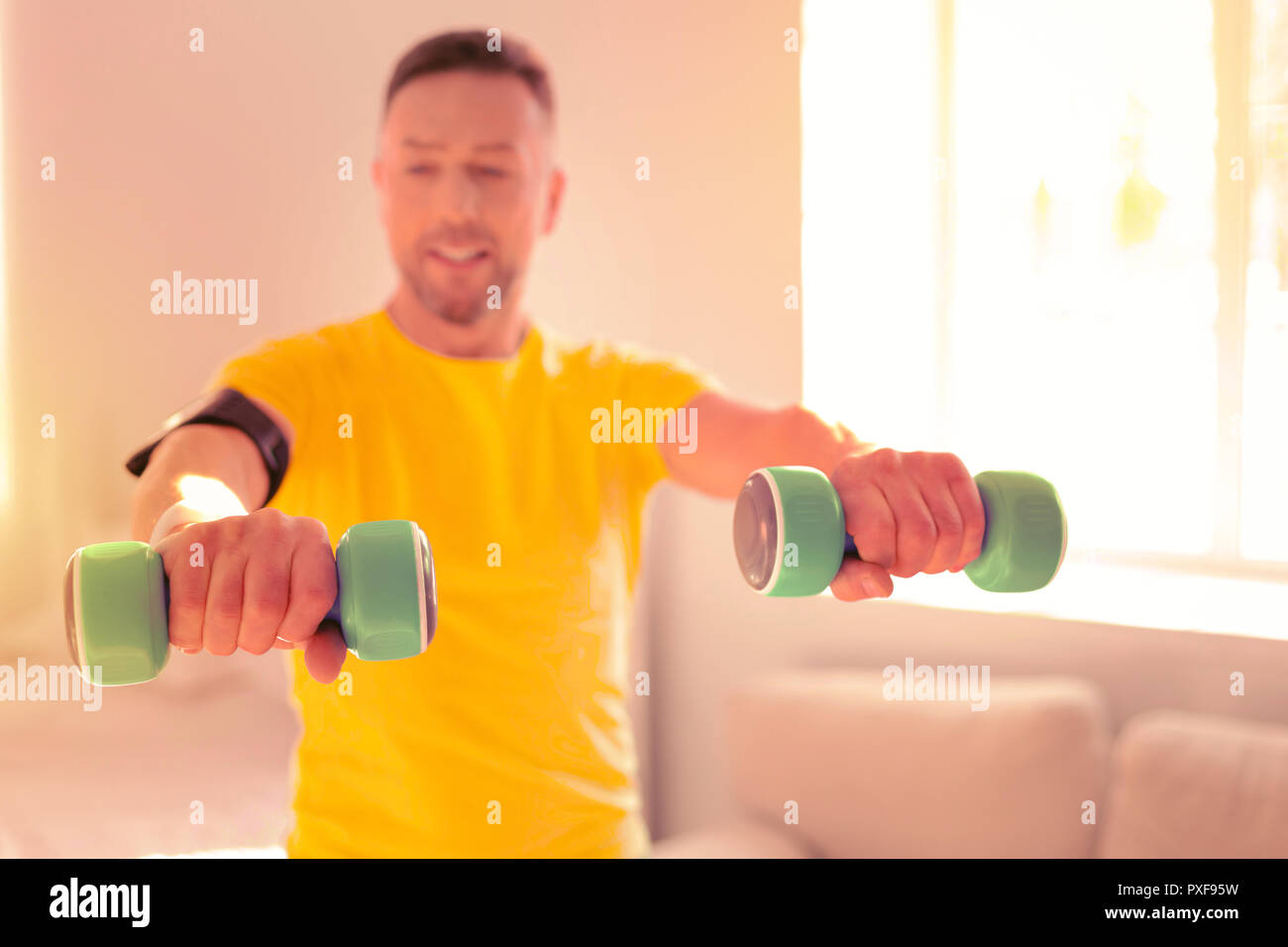 Energetic man exercising in the room at home Stock Photo - Alamy