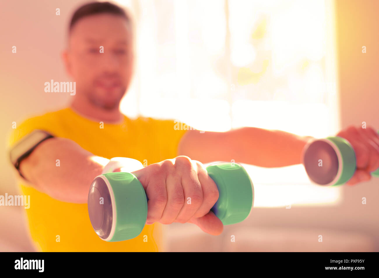 Active inspired man making different exercises at home Stock Photo - Alamy