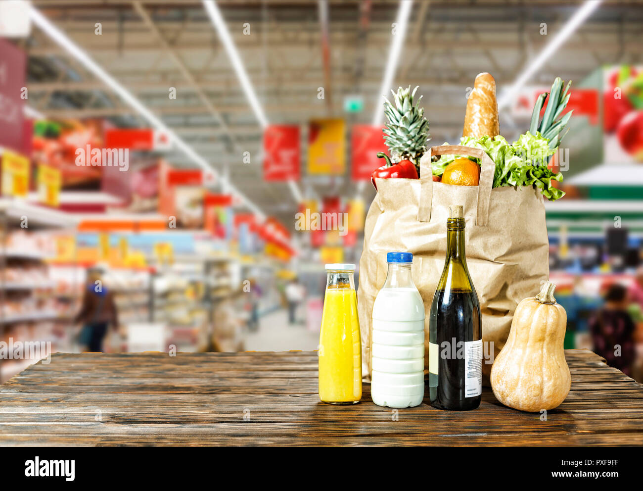 Paper bag with various food is on the table in the background of a ...