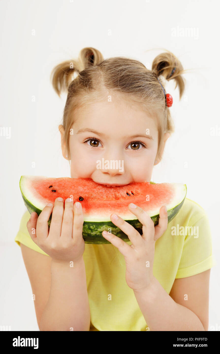 Little girl biting watermelon slice, concept of healthy eating ...