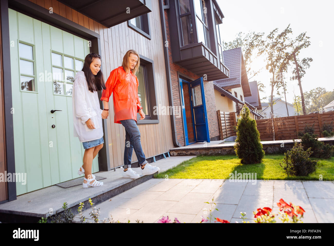 Pleasant nice young couple leaving the house Stock Photo - Alamy