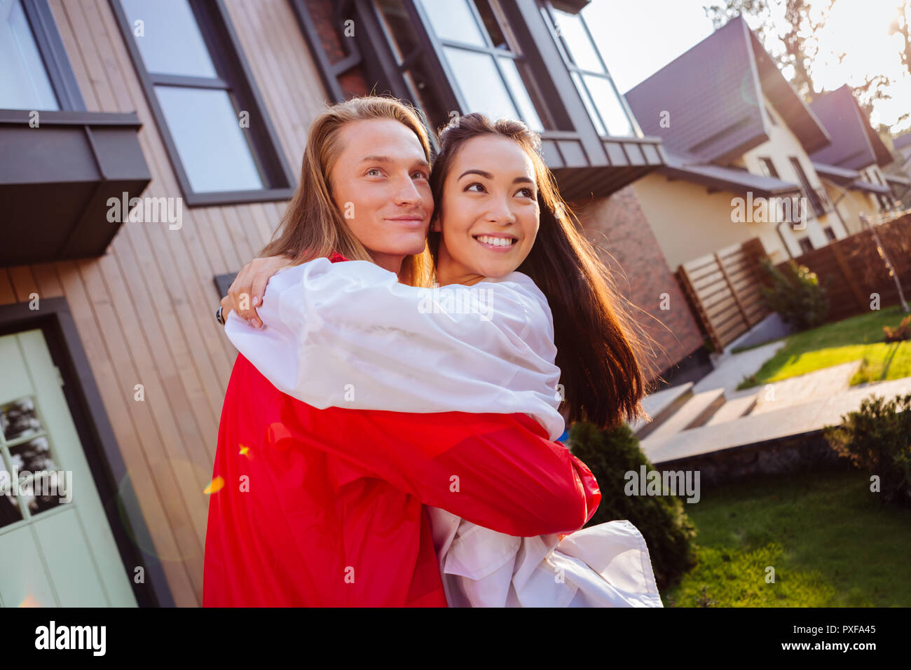 Nice positive young couple hugging each other Stock Photo - Alamy