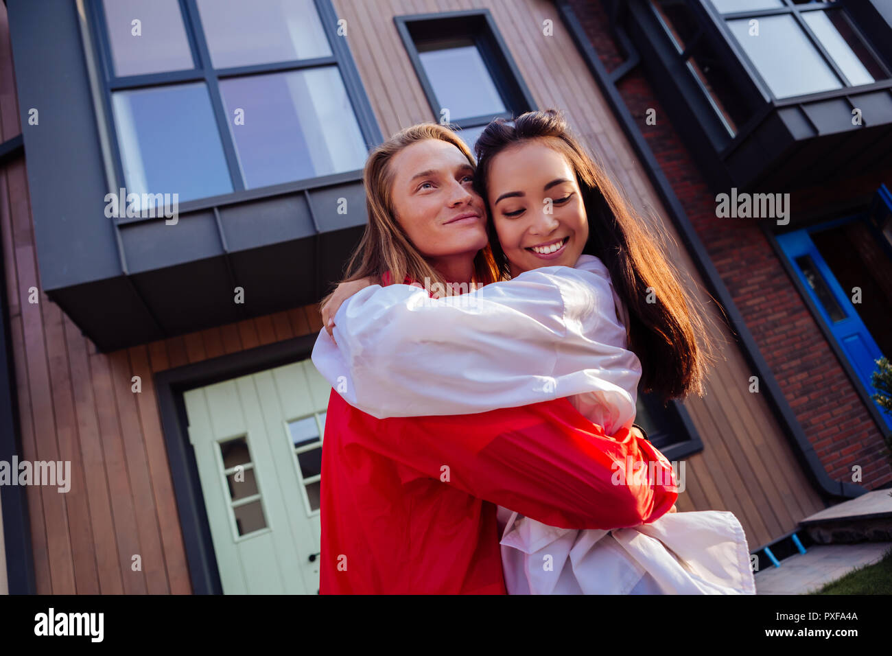 Low angle of a joyful positive couple Stock Photo - Alamy