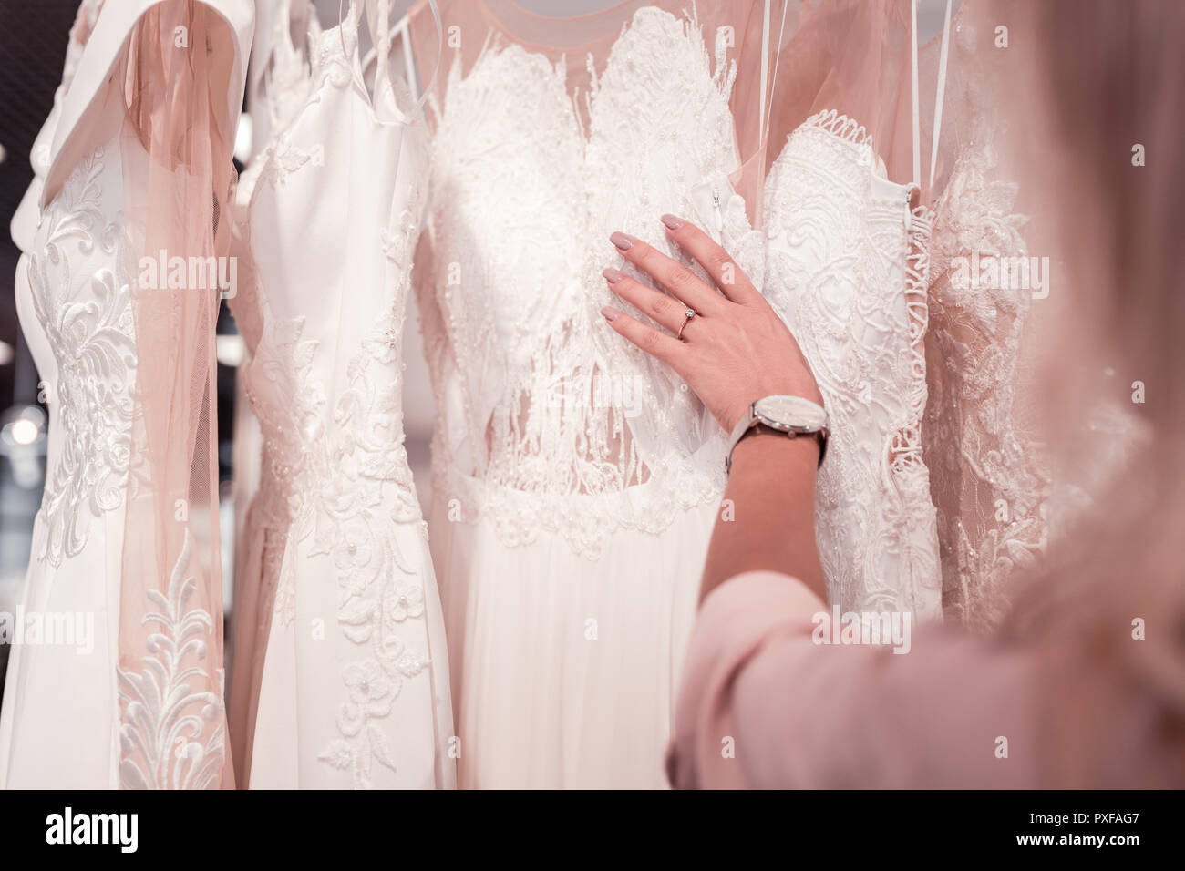 Female hand touching a beautiful wedding dress Stock Photo - Alamy