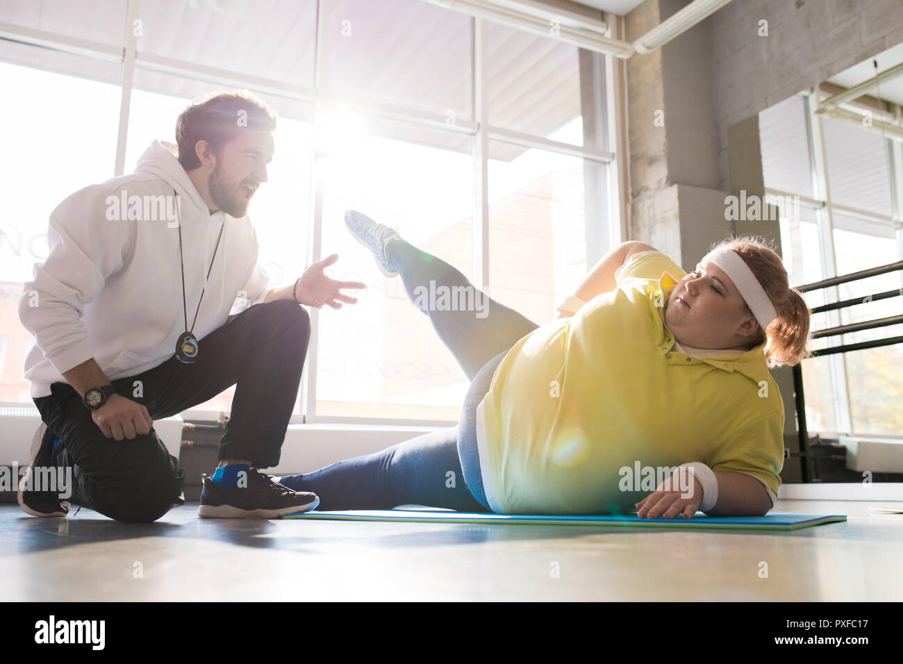 Fat Young Woman Working Out with Coach Stock Photo - Alamy