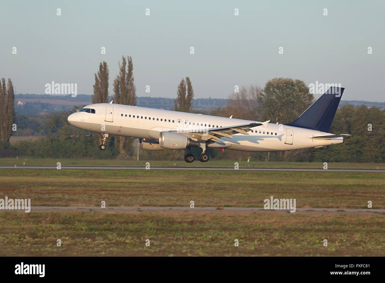 Plane landing on runway Stock Photo - Alamy