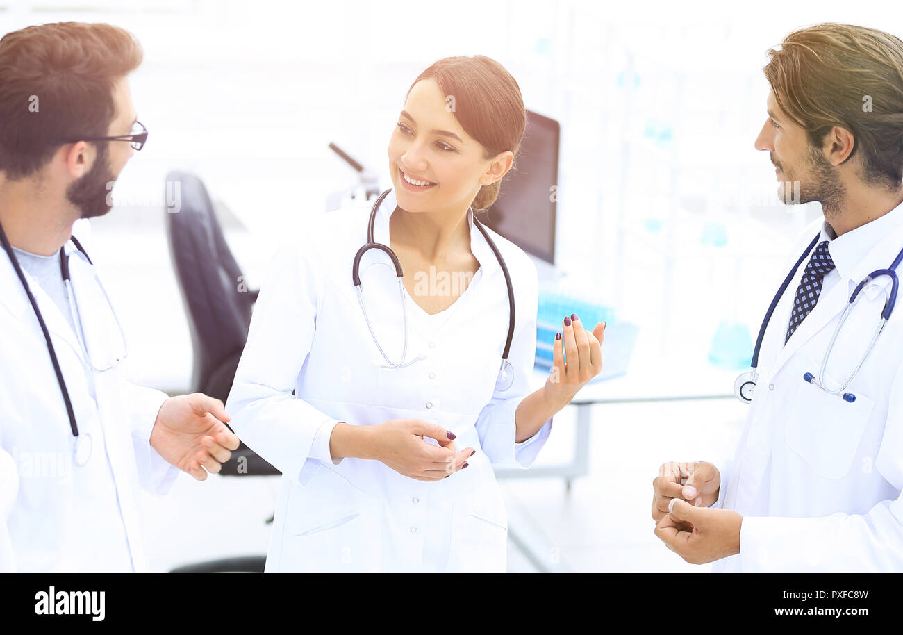 Team of different doctors having conversation Stock Photo - Alamy