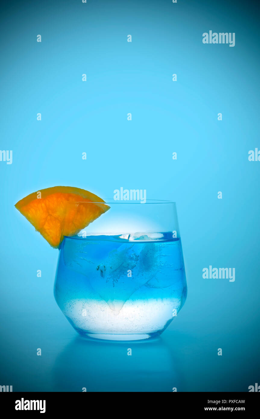 Fancy Blue Drink with Ice and Orange Slice Stock Photo - Alamy