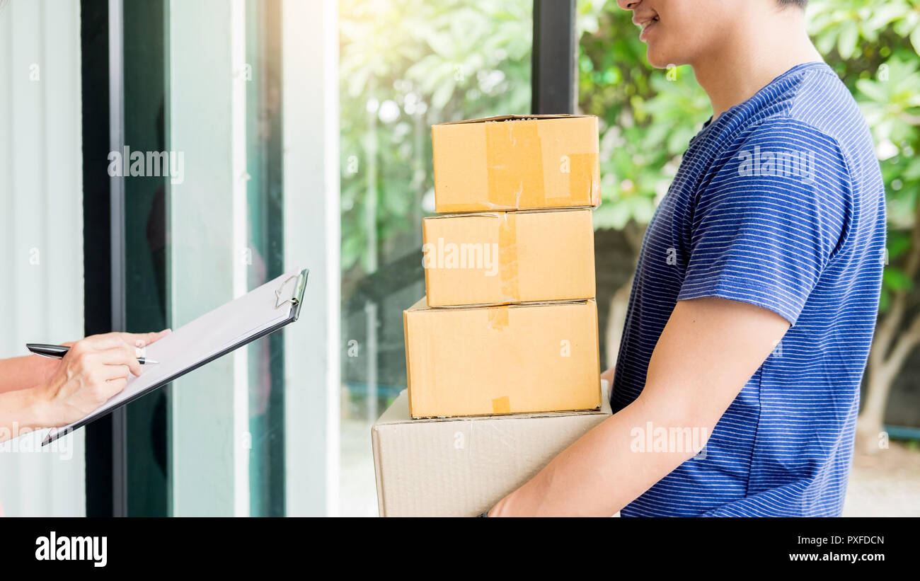 woman courier holding a parcel Shipping Mail appending signature ...