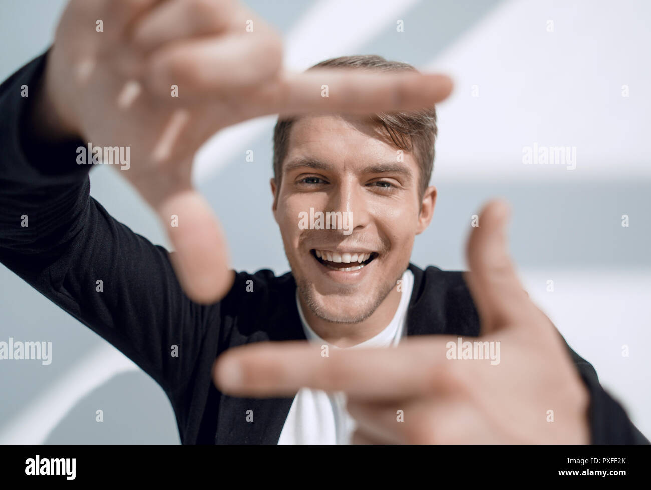 Young man making finger frame hands hi-res stock photography and images ...