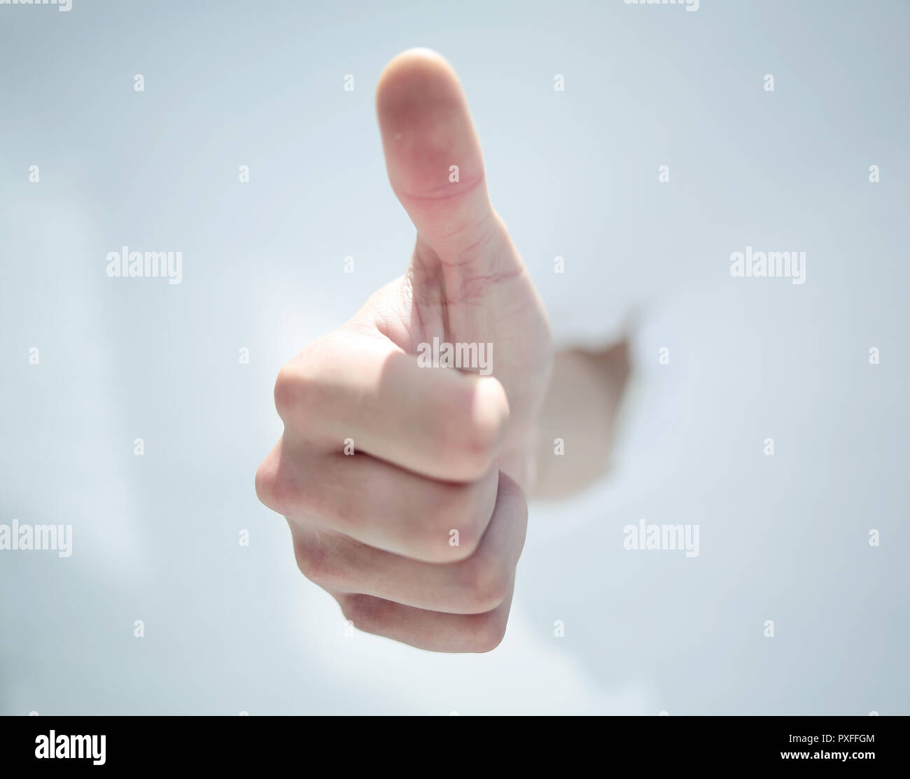 close up.a man's hand breaking through the paper and pointing so Stock ...