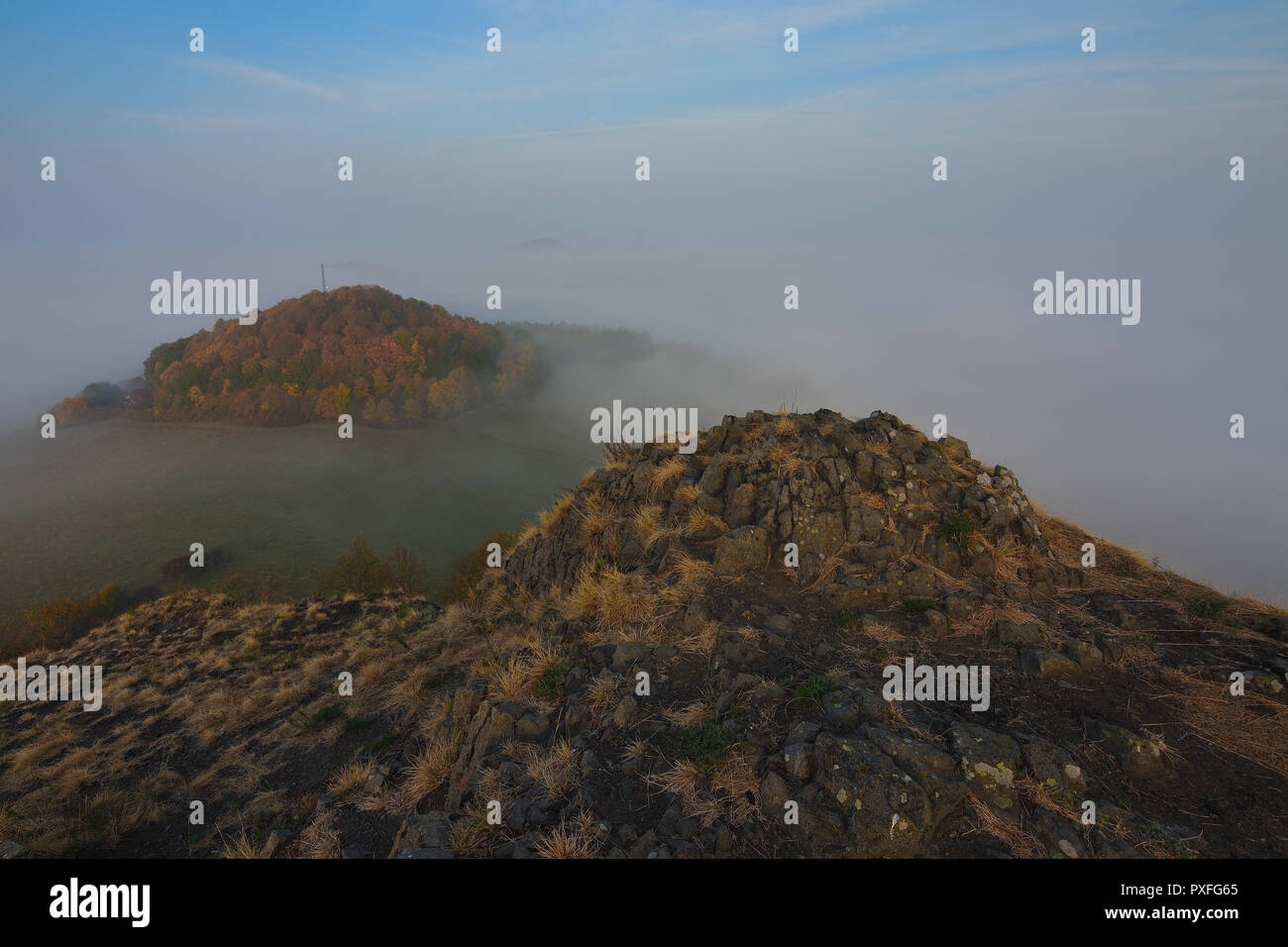 The rocky peak with daybreak. Full moon night ends and sun appeared in ...