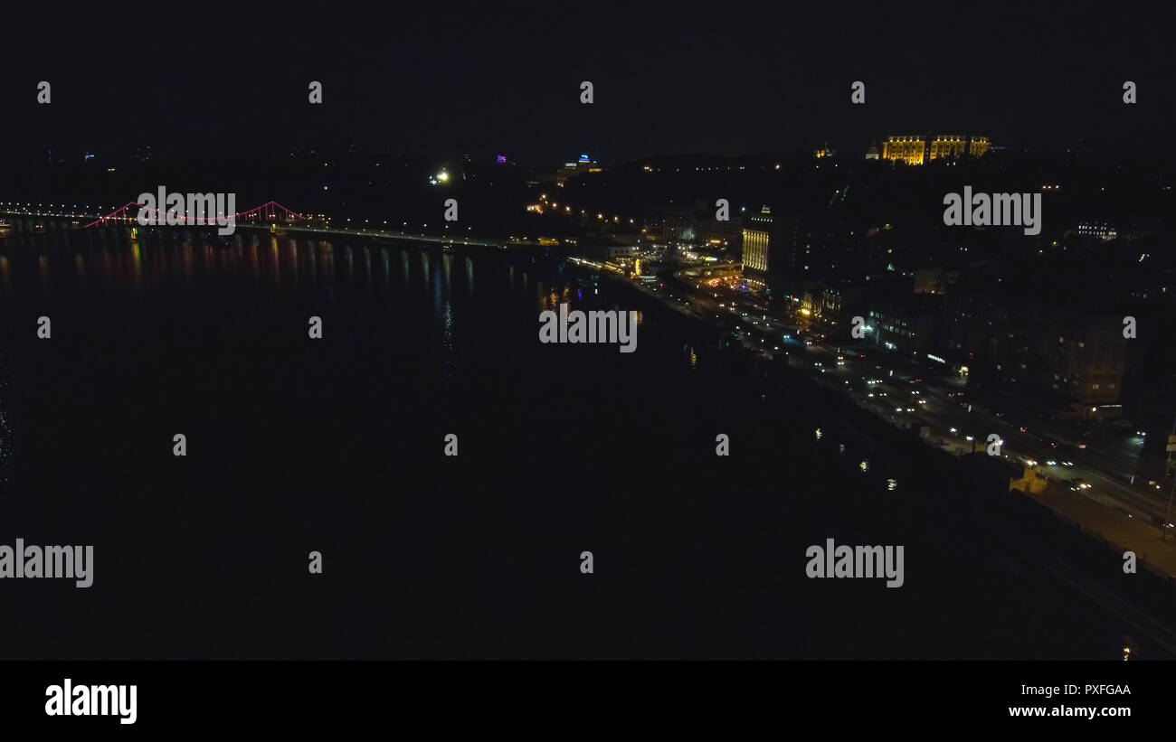 Aerial view from Drone: Top view of the night promenade with bridges ...