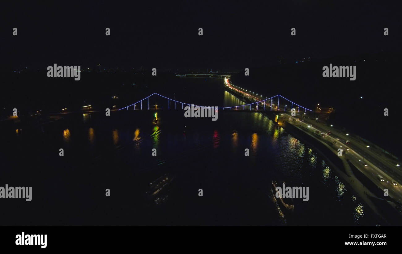 Aerial view from Drone: Top view of the night promenade with bridges ...