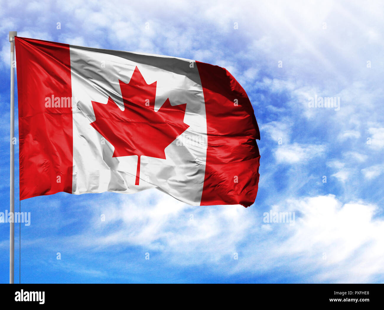 National flag of Canada on a flagpole in front of blue sky Stock Photo ...