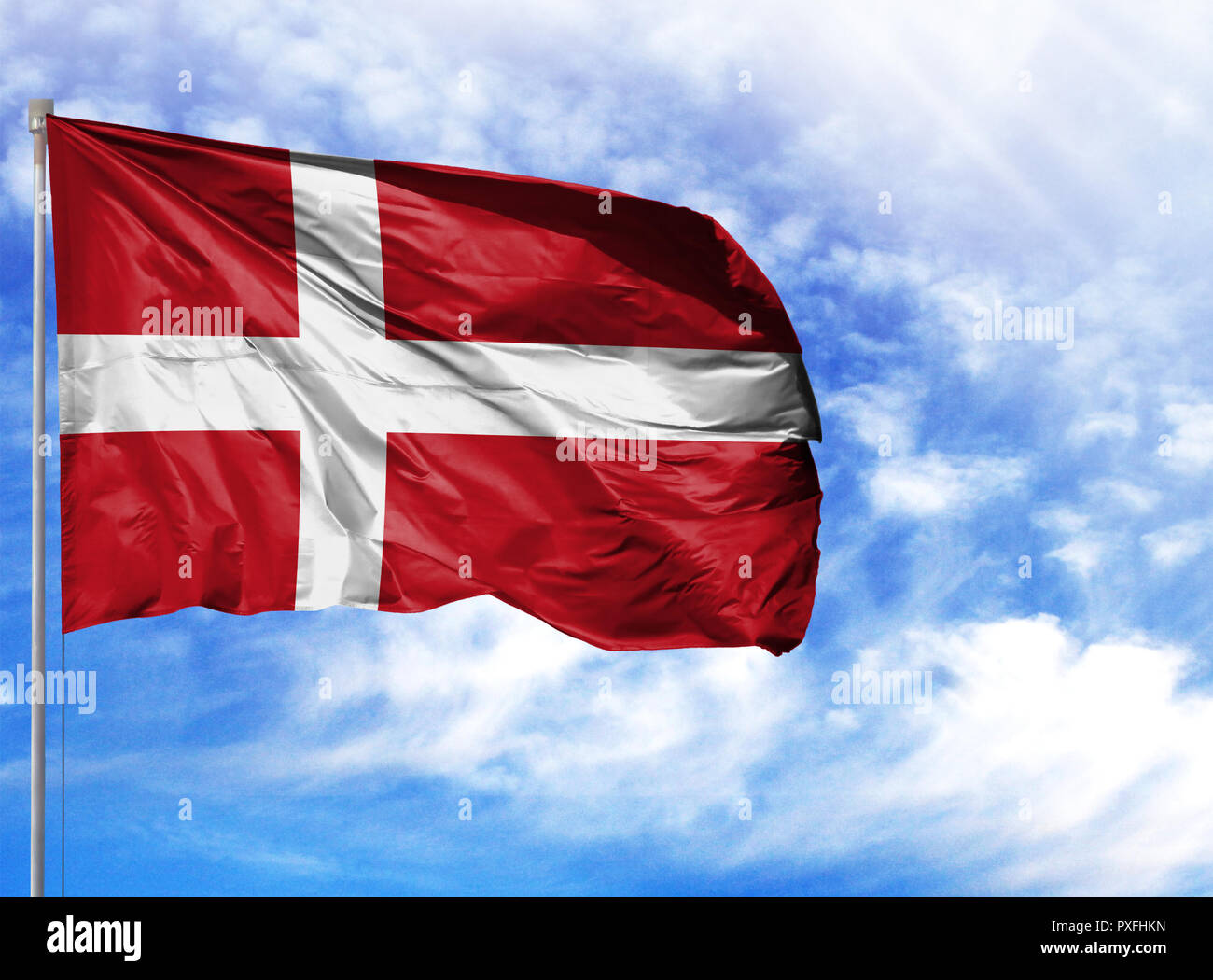 National flag of Denmark on a flagpole in front of blue sky Stock Photo ...