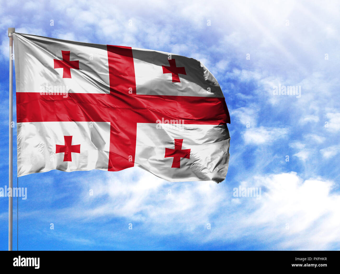 National flag of Georgia on a flagpole in front of blue sky Stock Photo ...