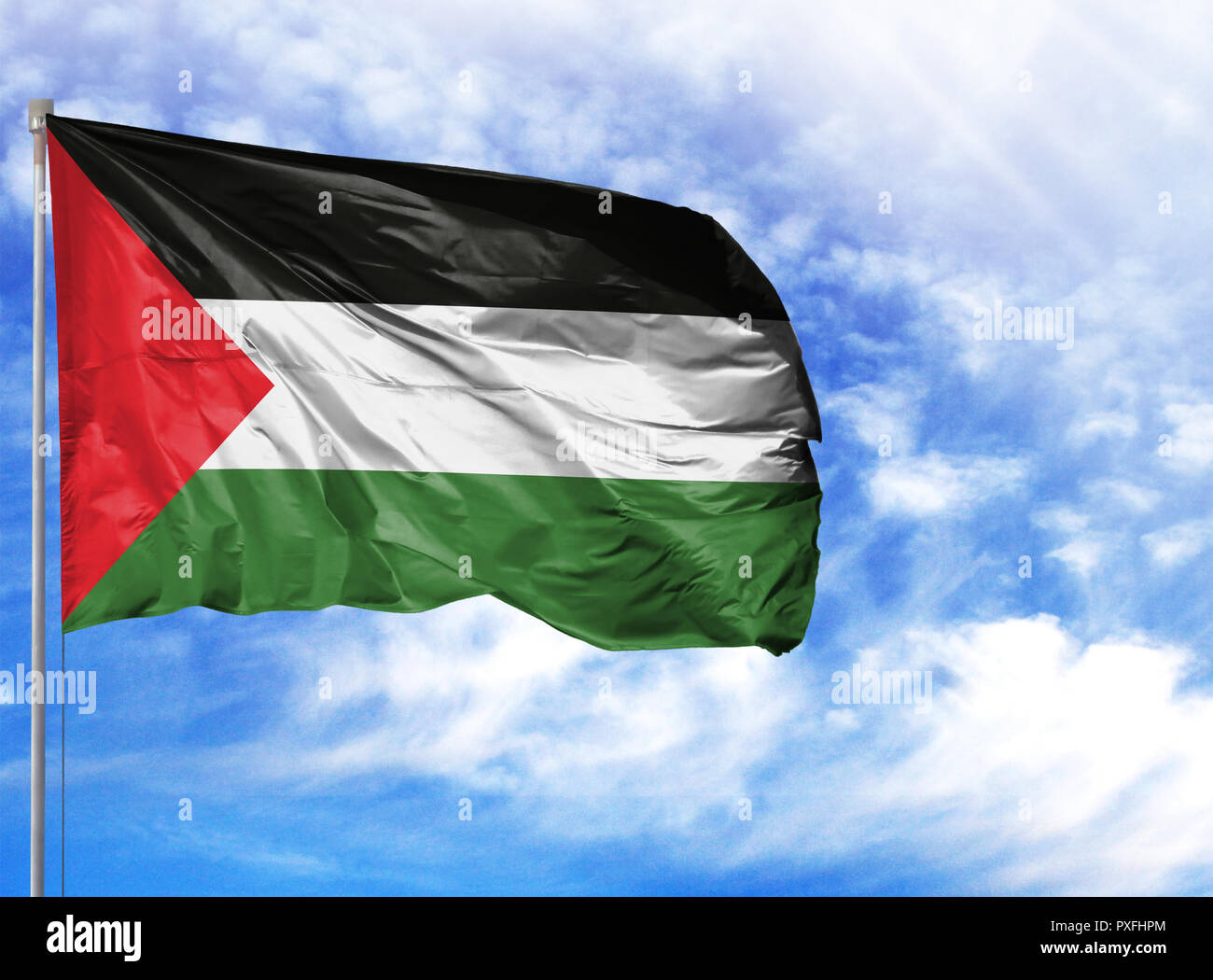 National flag of Palestine on a flagpole in front of blue sky Stock ...