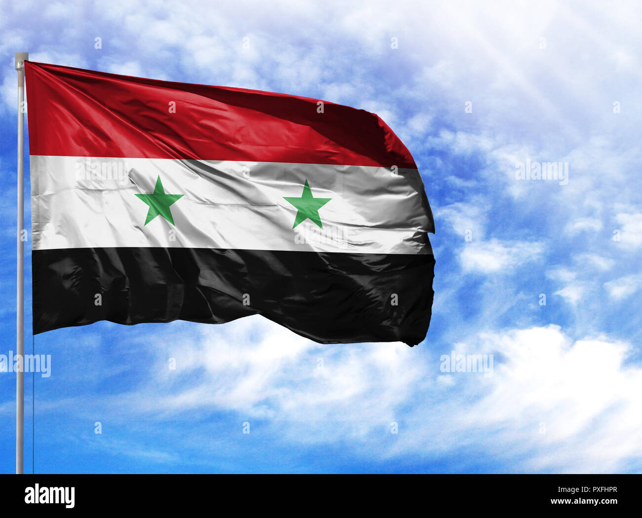 National flag of Syria on a flagpole in front of blue sky Stock Photo ...