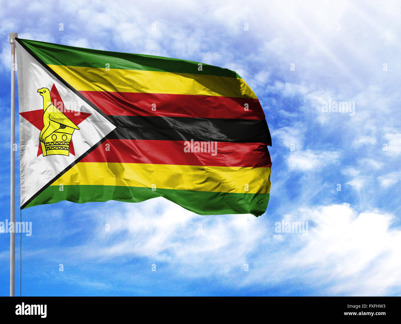 National flag of Zimbabwe on a flagpole in front of blue sky Stock ...