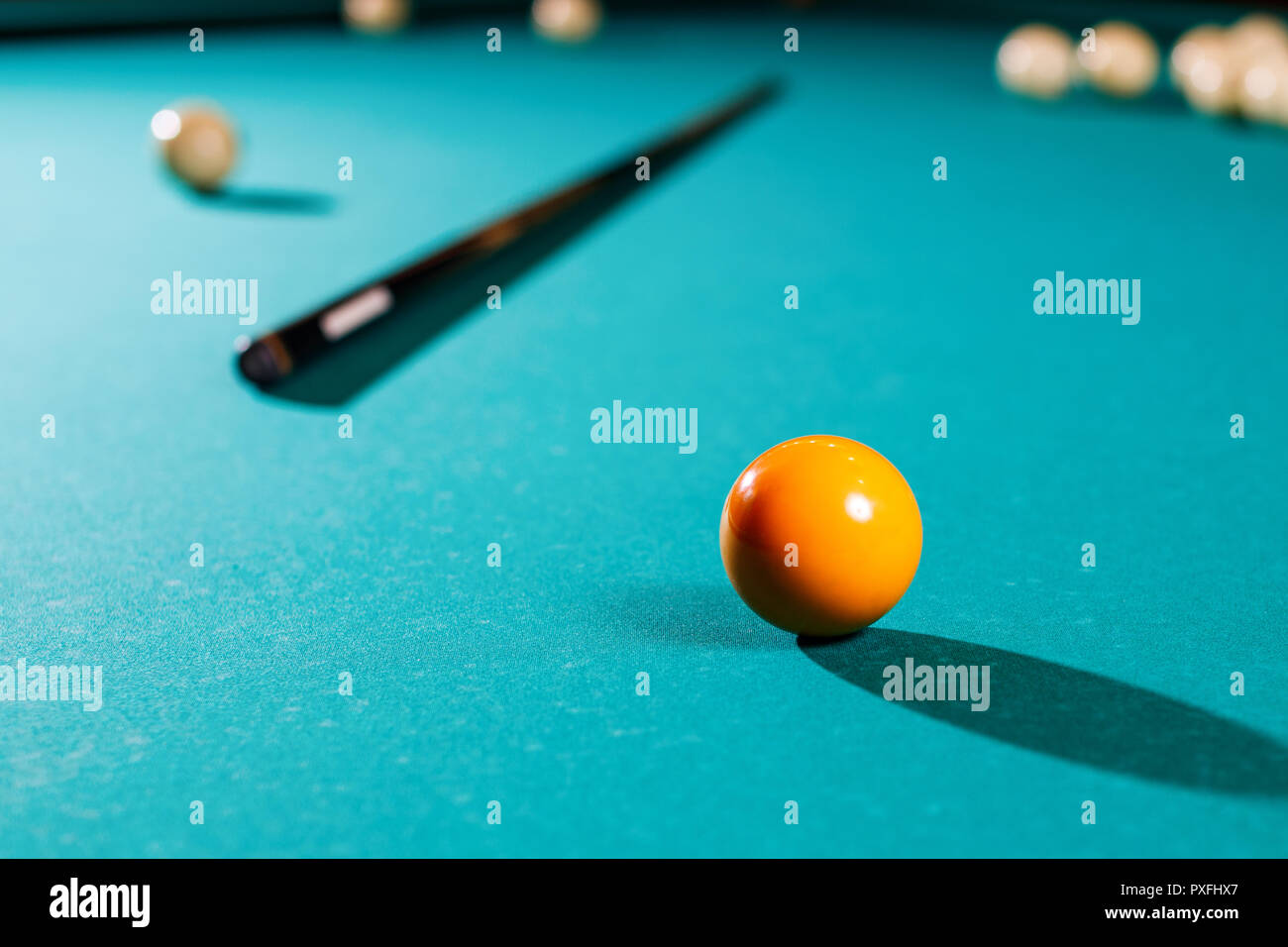 Billiard balls on green table with billiard cue Stock Photo - Alamy