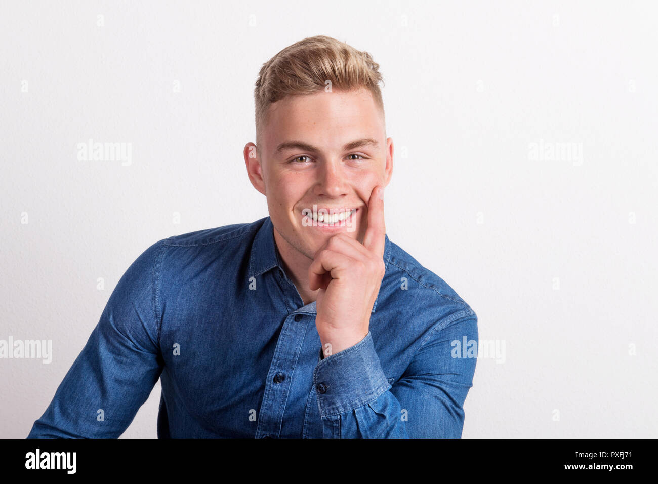 Blond male model wearing blue shirt hi-res stock photography and images ...