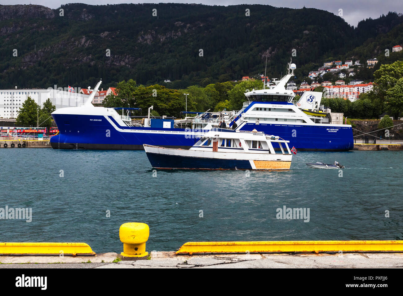 Small private passenger ship Albatross in front of the large modern ...