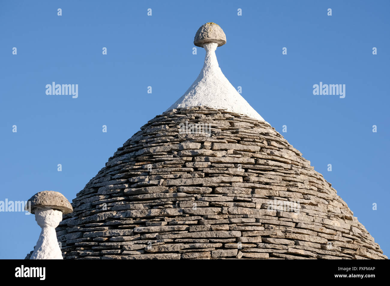 Close up of traditional conical, dry stone roofed trulli houses in the ...