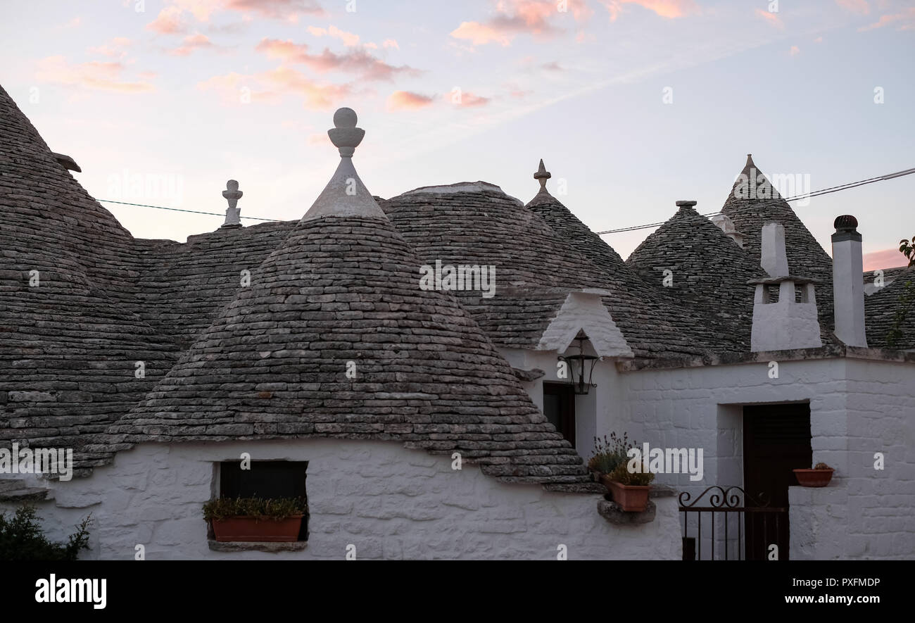 Close up of traditional conical, dry stone roofed trulli houses in the ...