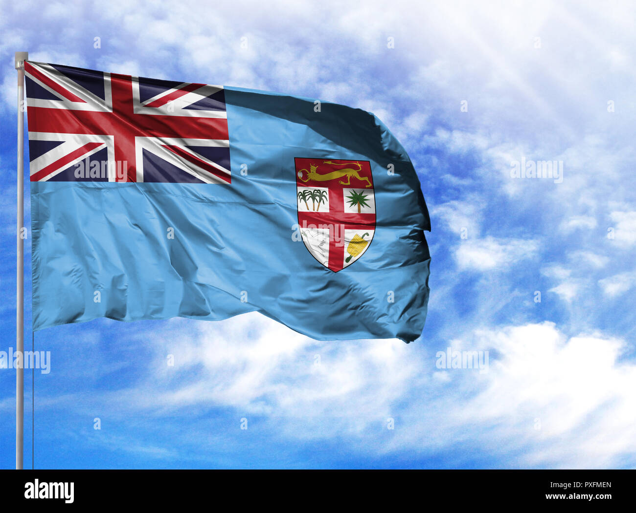 National flag of Fiji on a flagpole in front of blue sky Stock Photo ...